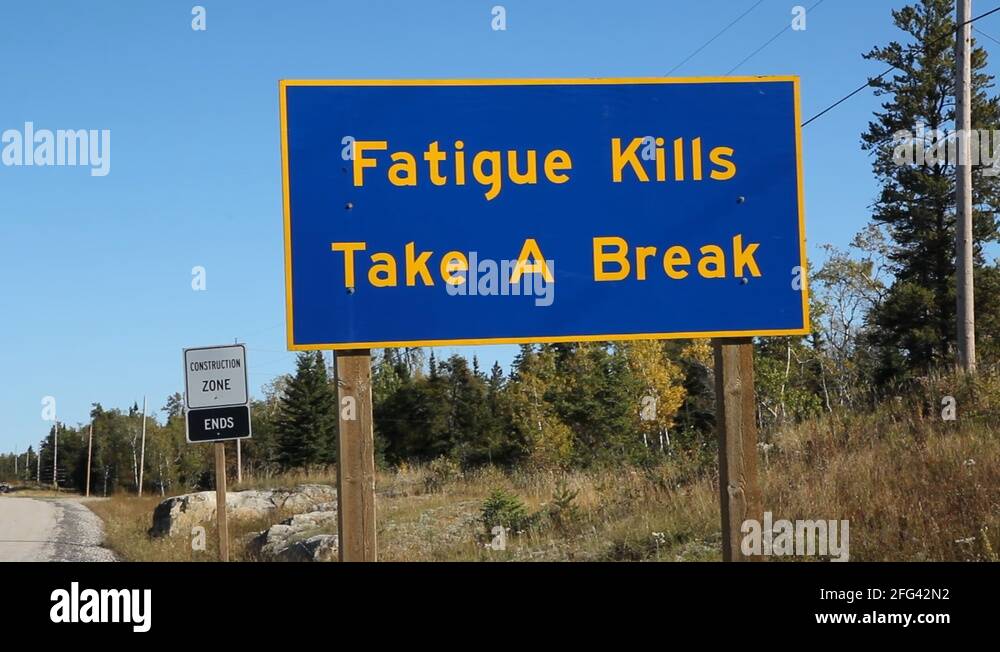 FATIGUE KILLS, TAKE A BREAK sign at side of highway Stock Video Footage ...