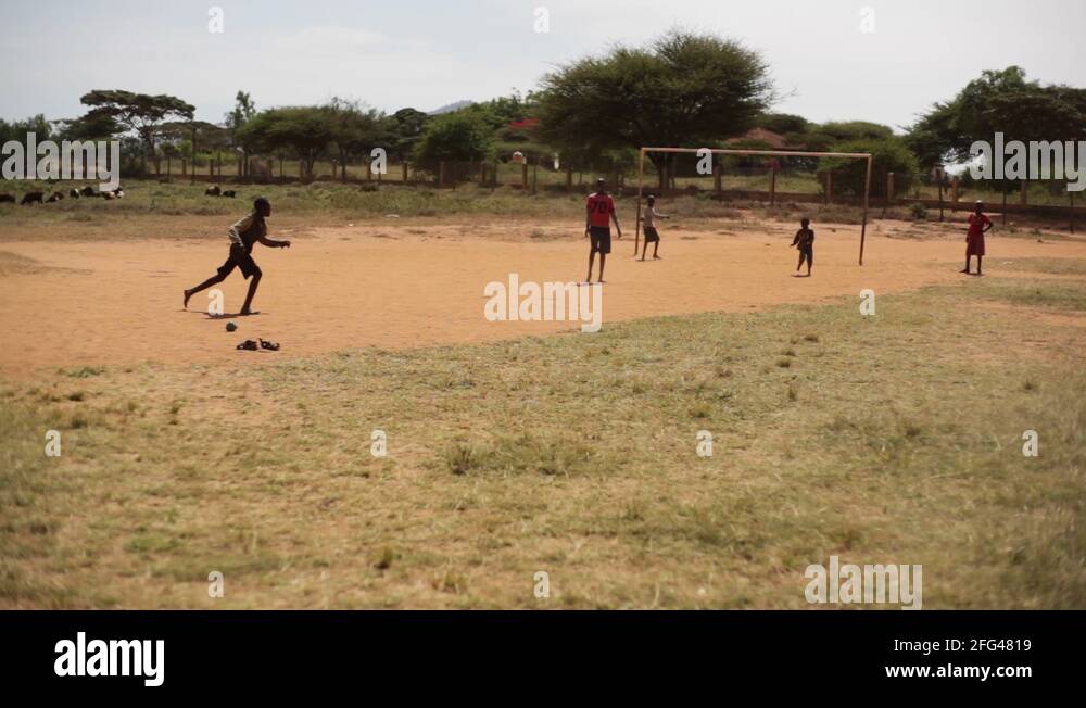 Poor African kids play football soccer, running to camera, Kenya ...