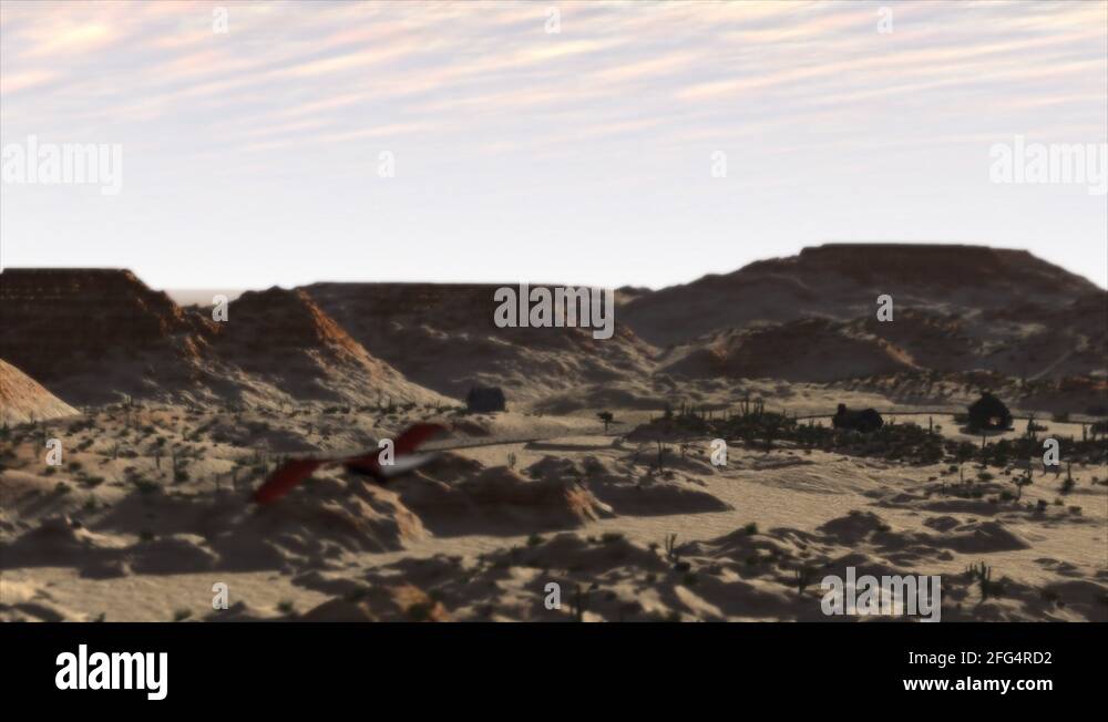 An aerial fly-over of a barren, desert landscape with primitive ...