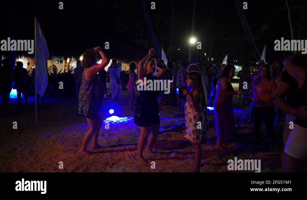 Women and couple dancing on the beach in Punta Cana at night Stock ...
