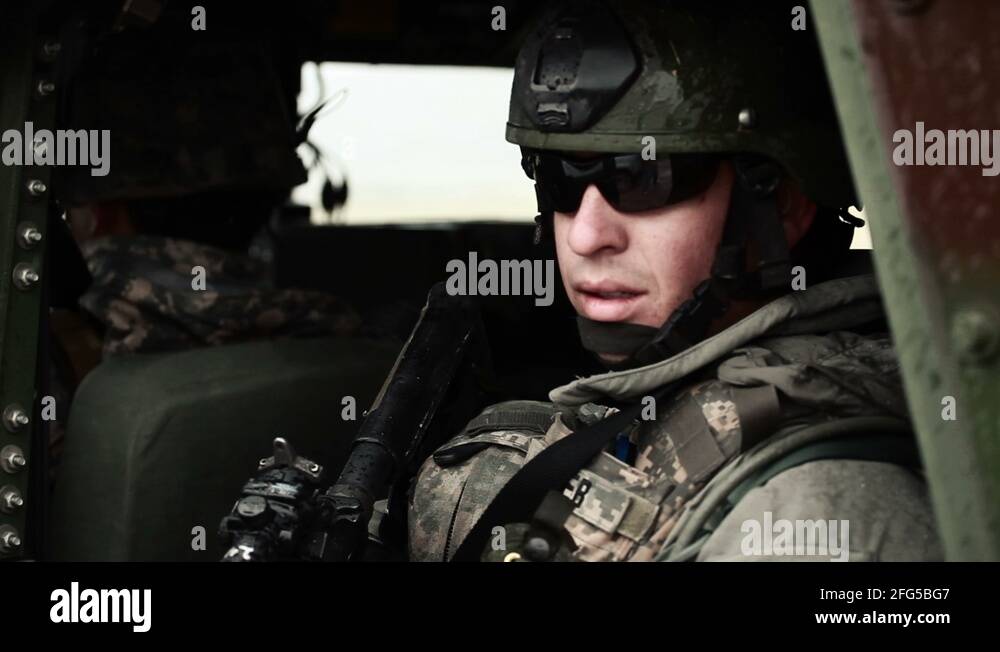 Soldier wearing sunglasses looking out side door of Humvee Stock Video ...