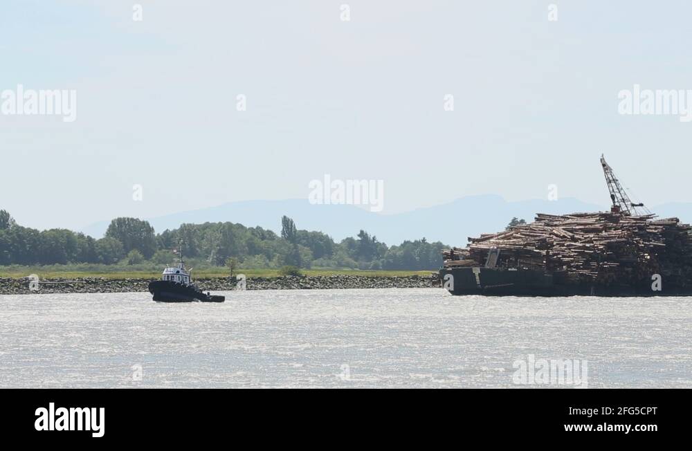 Tugboat Towing Log Barge Stock Video Footage - Alamy