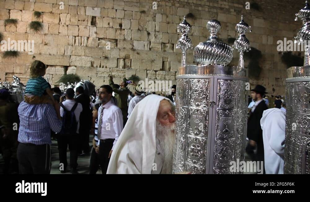 A very old rabbi hugs and kisses Bible Torah scroll inaugurated in ...