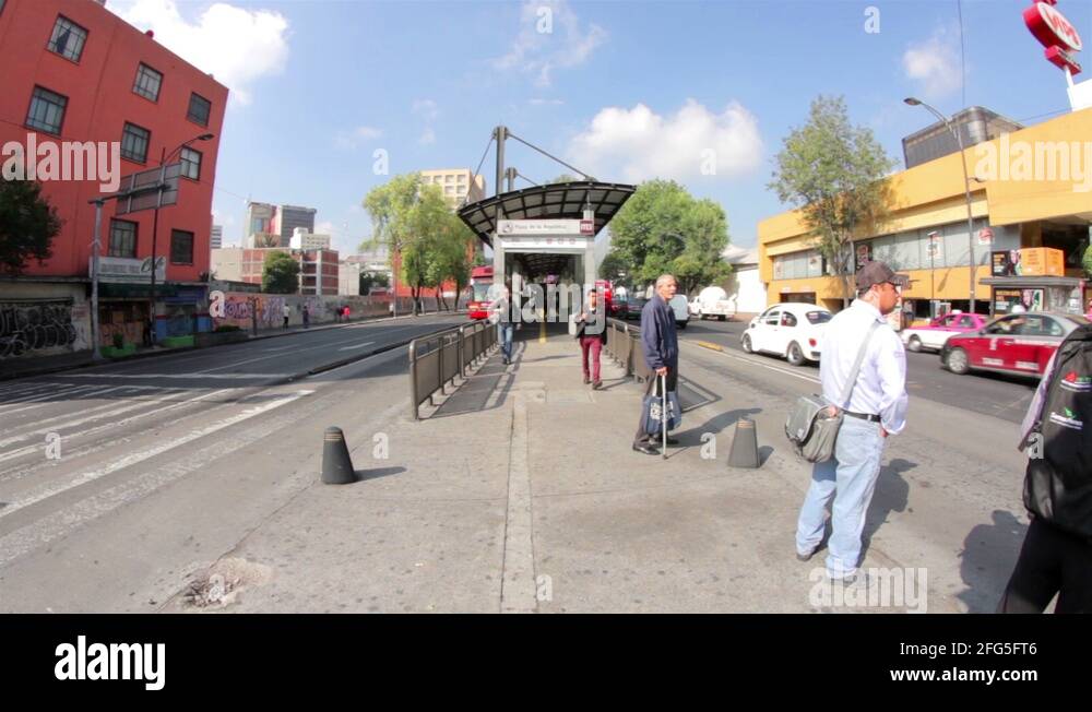Metrobus bus stop, people crossing street and taking public transport ...