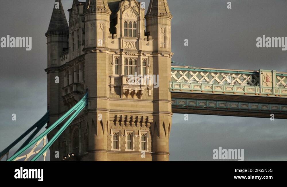 Dark clouds behind the top of the left tower on Tower Bridge in London ...