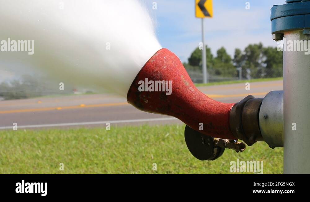 Cars Pass in Background of Fire Hydrant While Flushing Stock Video ...