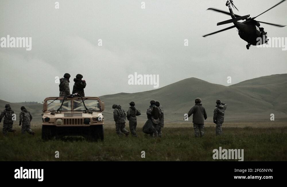 Shot of soldiers in Humvee while Black Hawk helicopter flies overhead ...