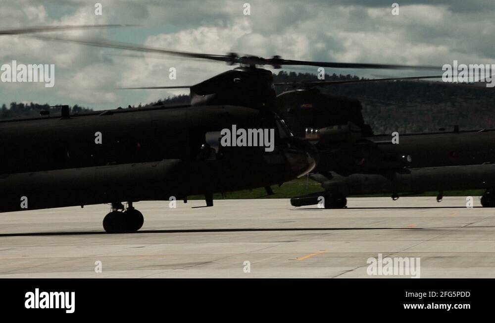 Soldiers board the chopper via the ramp into the open hatch at the back ...