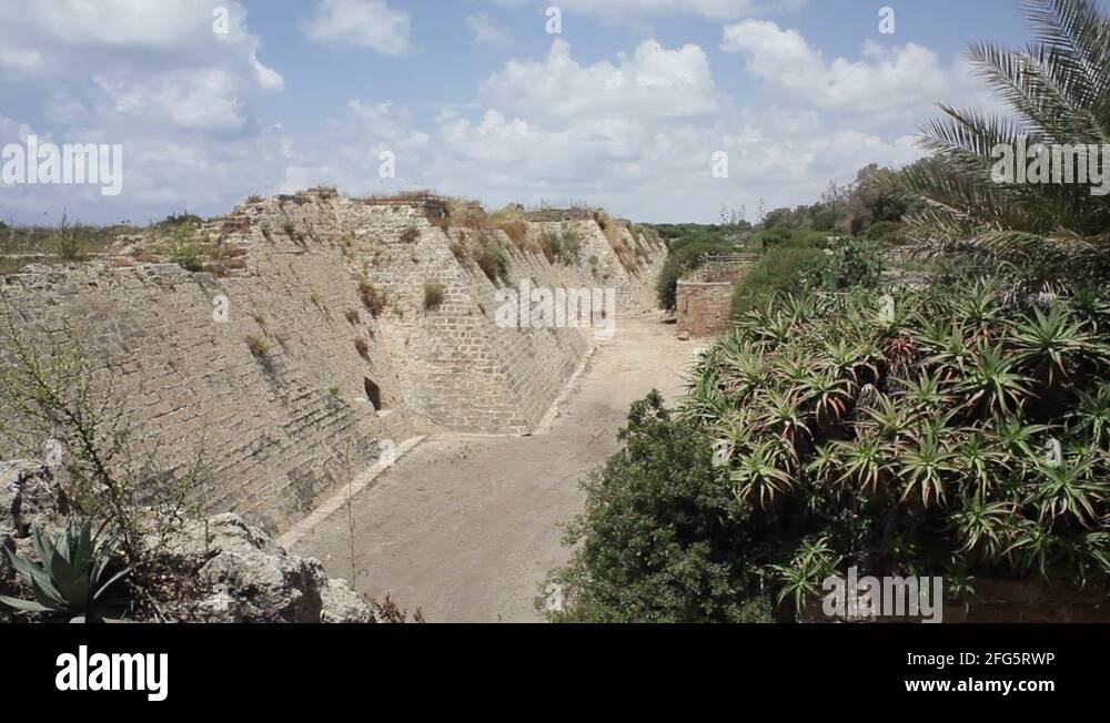 Ancient fortified walls with dry moat in the ancient Roman city of ...