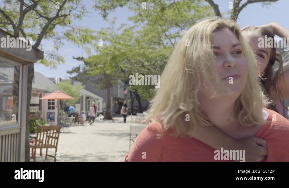 Teens Walk Around Wharf On Nantucket, Girl gives Friend A Piggyback ...
