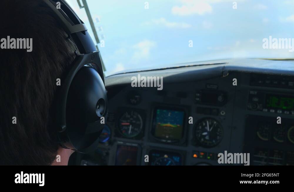 Pilot with Radio Headset Operating Aircraft Stock Video Footage - Alamy