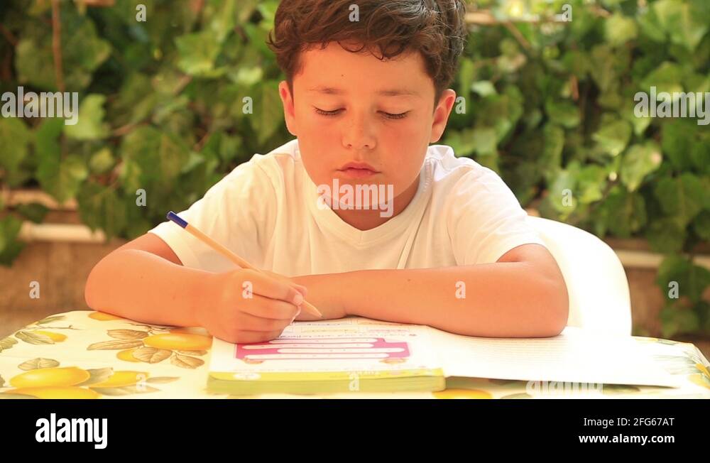 Cute kid doing homework Stock Video Footage - Alamy