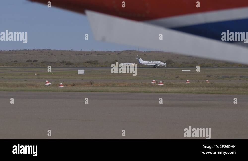 RFDS Flying Doctor plane taxis, tail logo tilt up Broken Hill airport ...