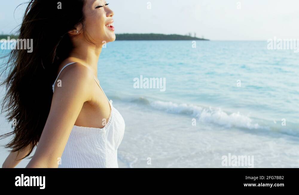 Beautiful Asian Chinese girl wearing white sundress on beach Stock ...