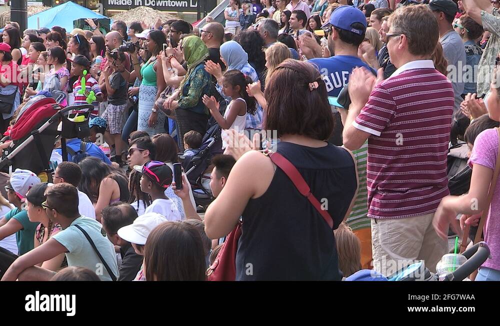 Large crowds of people and performers at Toronto busker festival in ...