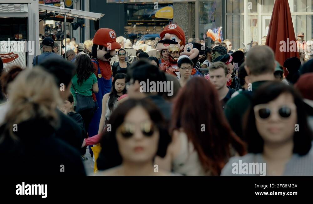 Chaotic busy crowd people tourists walking Times Square NYC New York ...