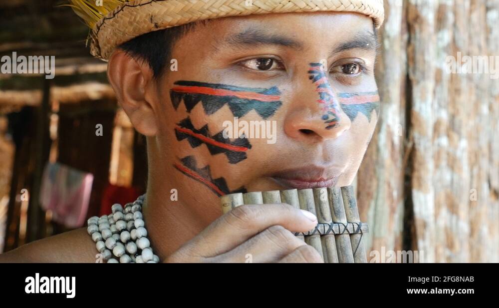 Native Brazilian playing wooden flute at an indigenous tribe in the ...