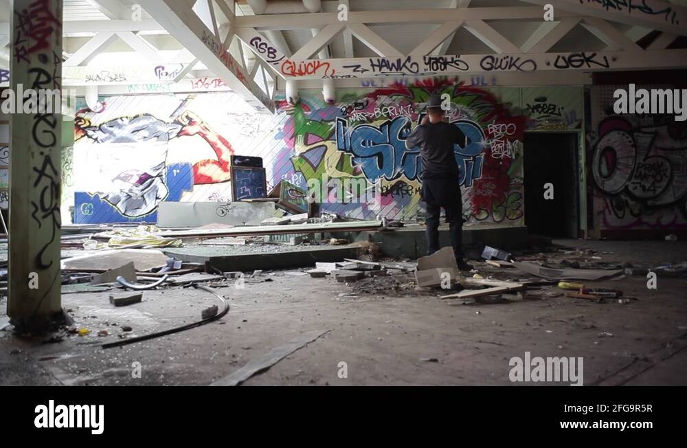 Graffiti artist takes photos of his new art piece in abandoned building ...