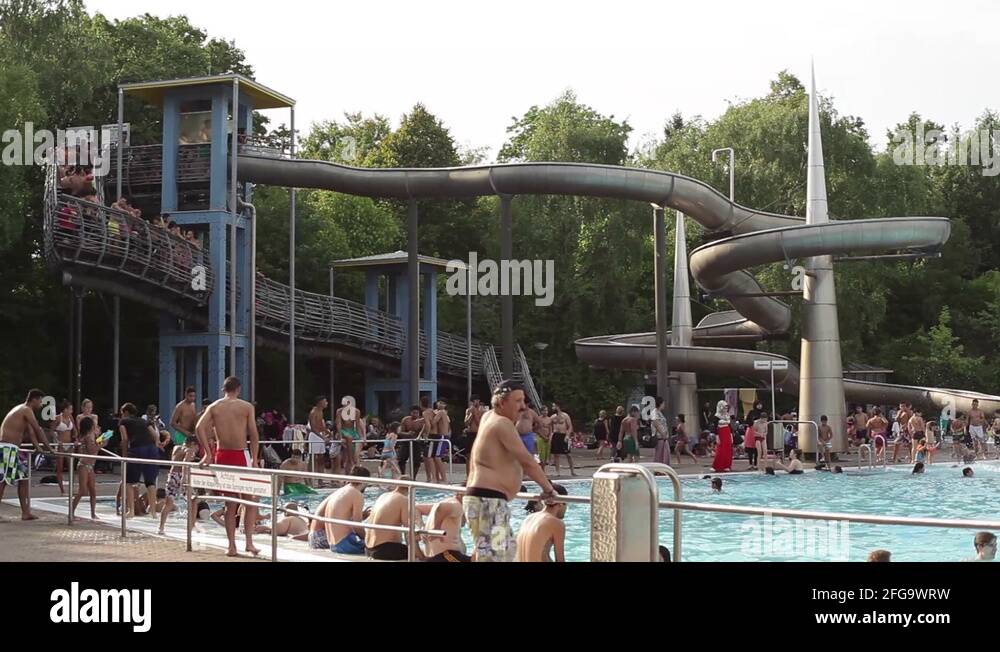 Kids wait in line on stairs for water slide, busy day at water park ...