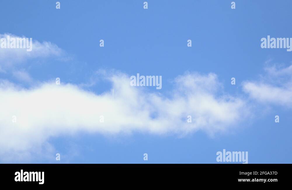 Jet stream in sky behind aircraft flying behind clouds 4k Stock Video ...