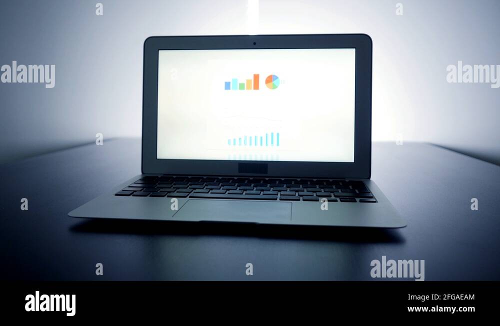 viewing business charts and diagrams background. working on laptop ...