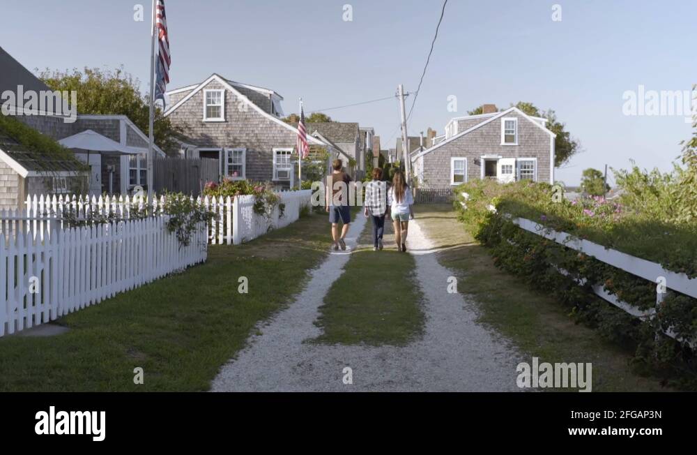 Teens Walk Down Shell Road, Lined With Cottages, In New England Seaside ...