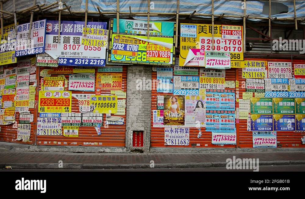Man pass wall covered by many notices and announcement placard and ...