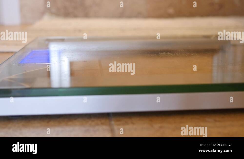 A mans feet step on scale to weigh himself Stock Video Footage - Alamy