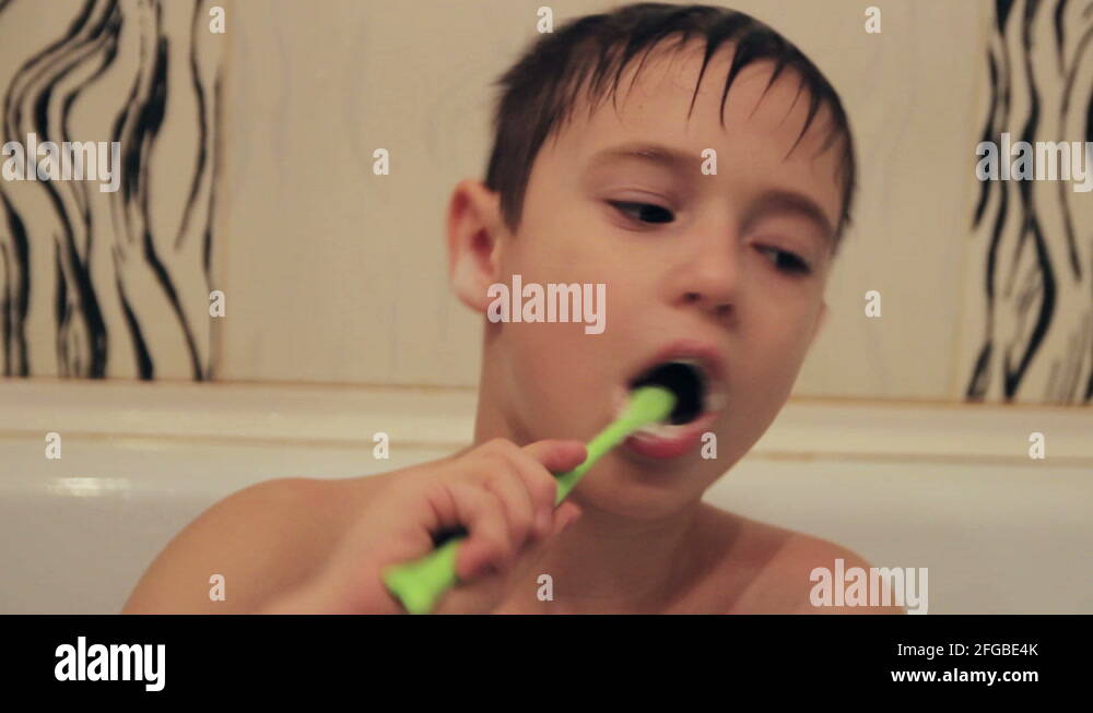 Young boy brushing his teeth Stock Video Footage - Alamy