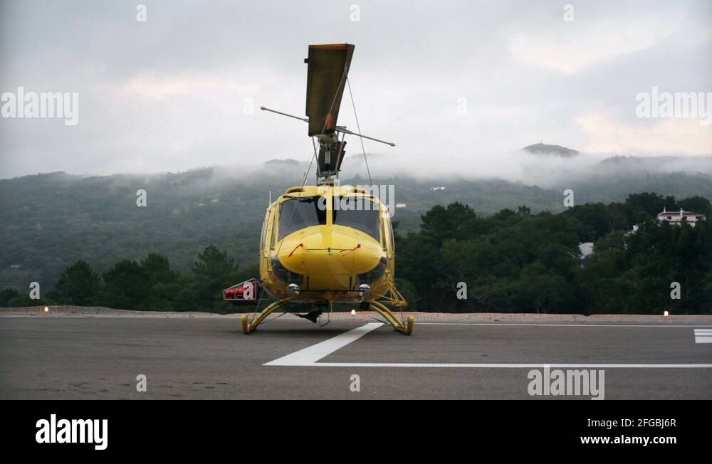 Yellow rescue helicopter chopper, front view, Monchique helipad ...