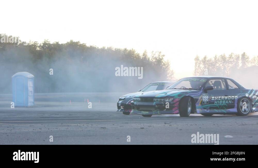 Two Nissan's drift side by side around corner at drifting practice ...