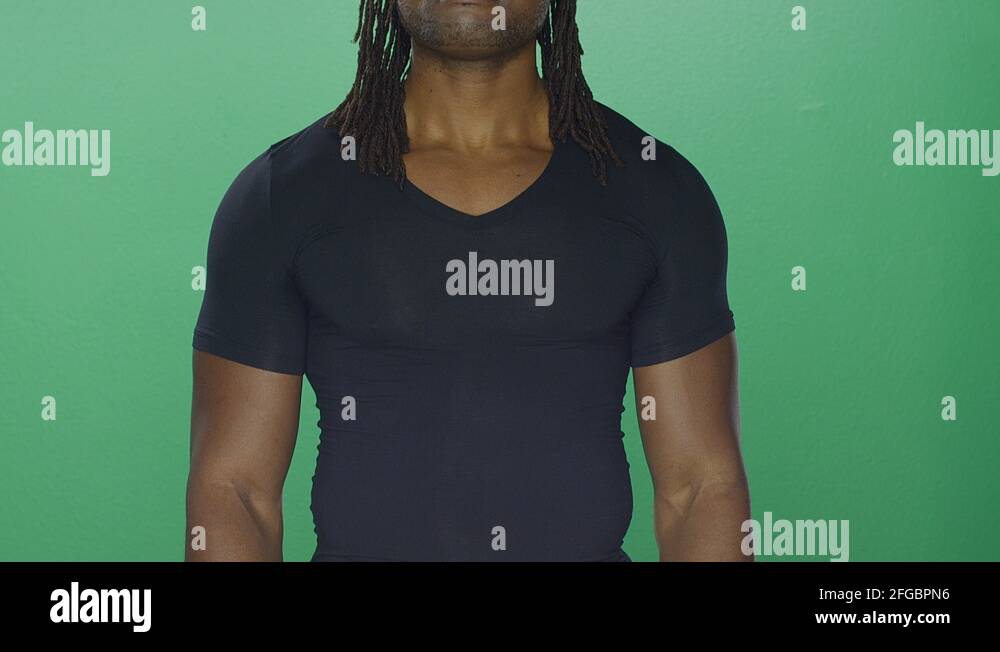 Athletic black man flexing his arms, on a green screen background Stock ...