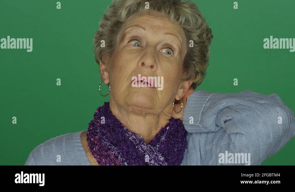 Older woman in disbelief and disappointed, on a green screen background ...