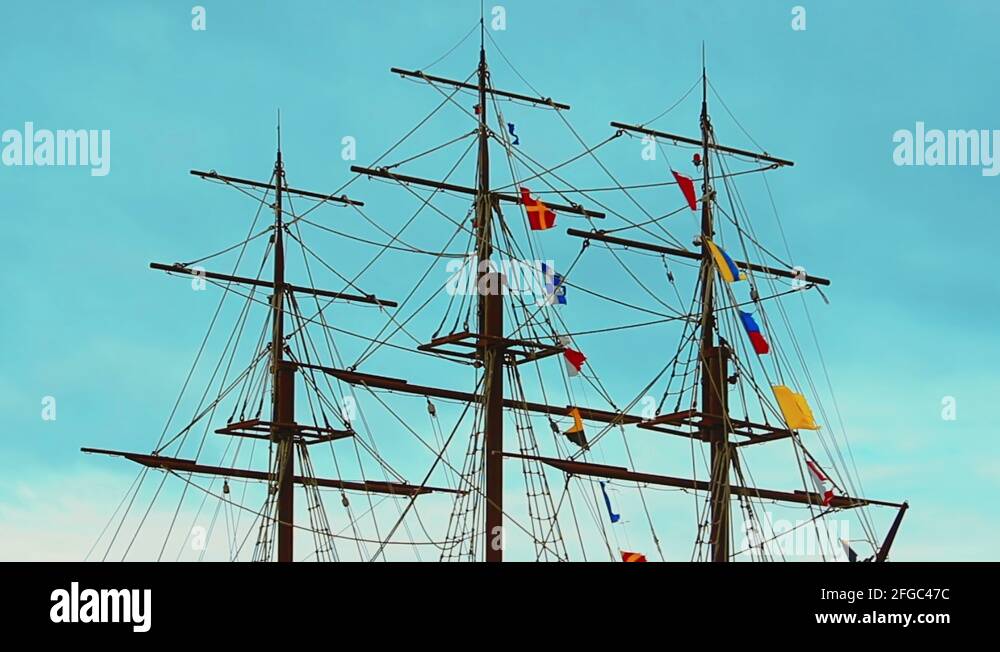 Three-masted frigate ship with colorful flags Stock Video Footage - Alamy
