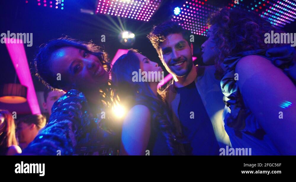 Party Couple making silly faces for selfie in night club Stock Video ...