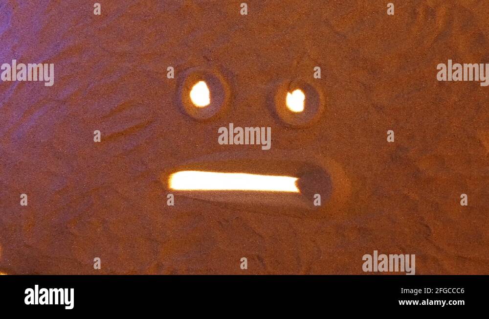 Hand drawing Serious Smile symbol in the sand. Beach background. Top ...