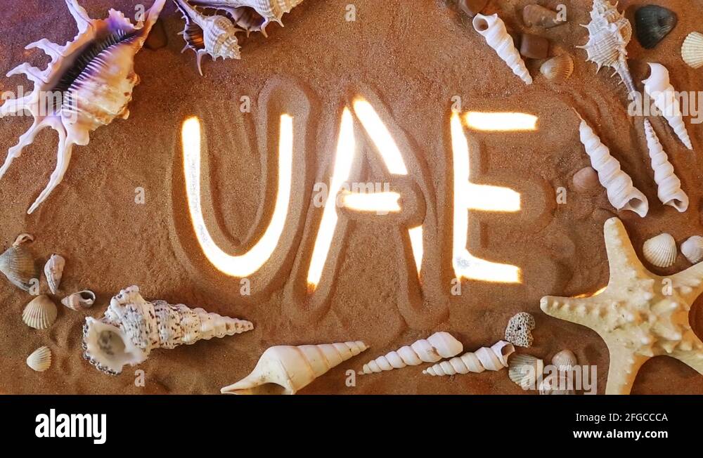 Hand drawing UAE symbol in the sand. Beach background. Top view Stock ...