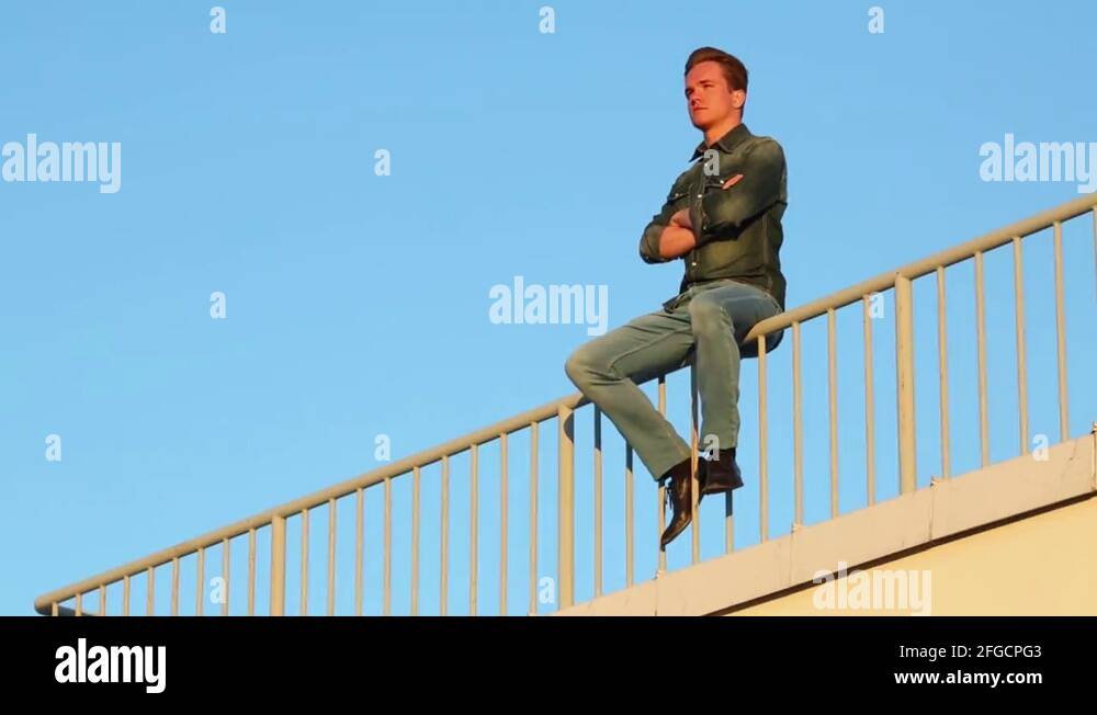 Man sitting on fence Stock Videos & Footage - HD and 4K Video Clips - Alamy