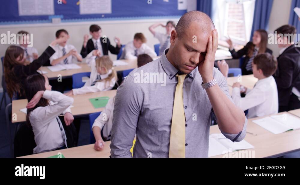 4k, Portrait of an unhappy class teacher while students wreak havoc ...