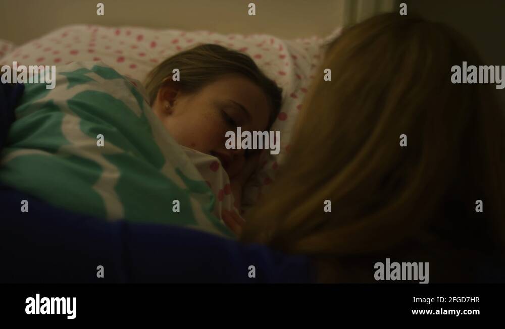 Mother tucking daughter into bed Stock Videos & Footage - HD and 4K ...