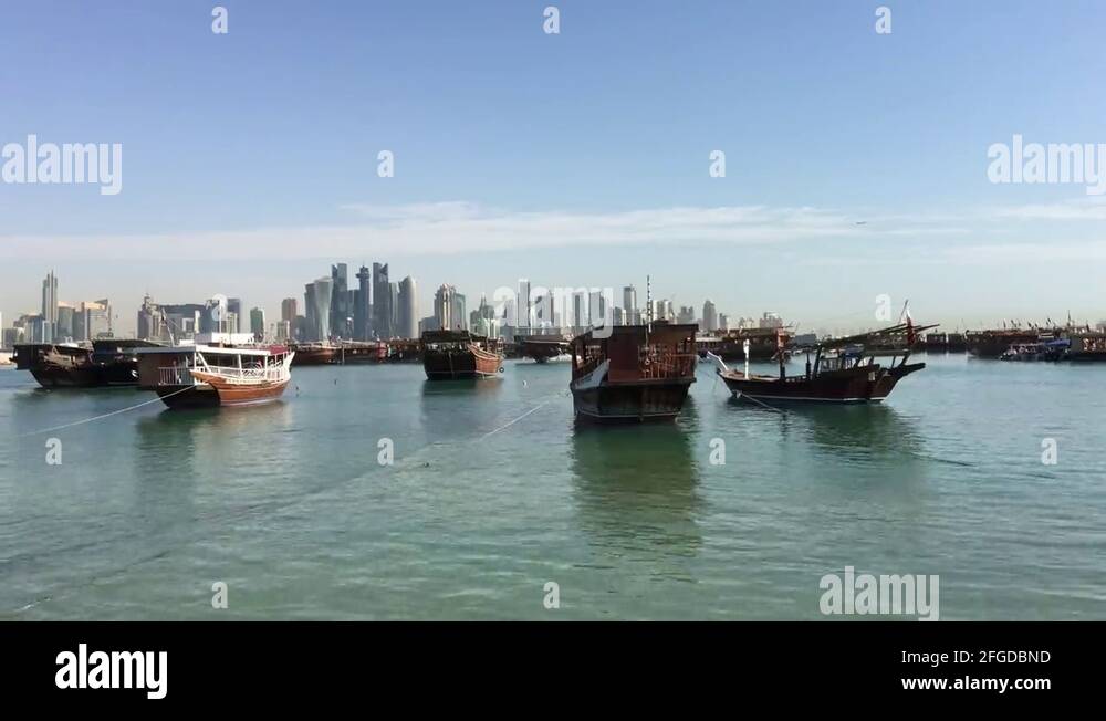 Traditional Dhow, Arab sailing vessels in Dhow Harbour and Doha skyline ...