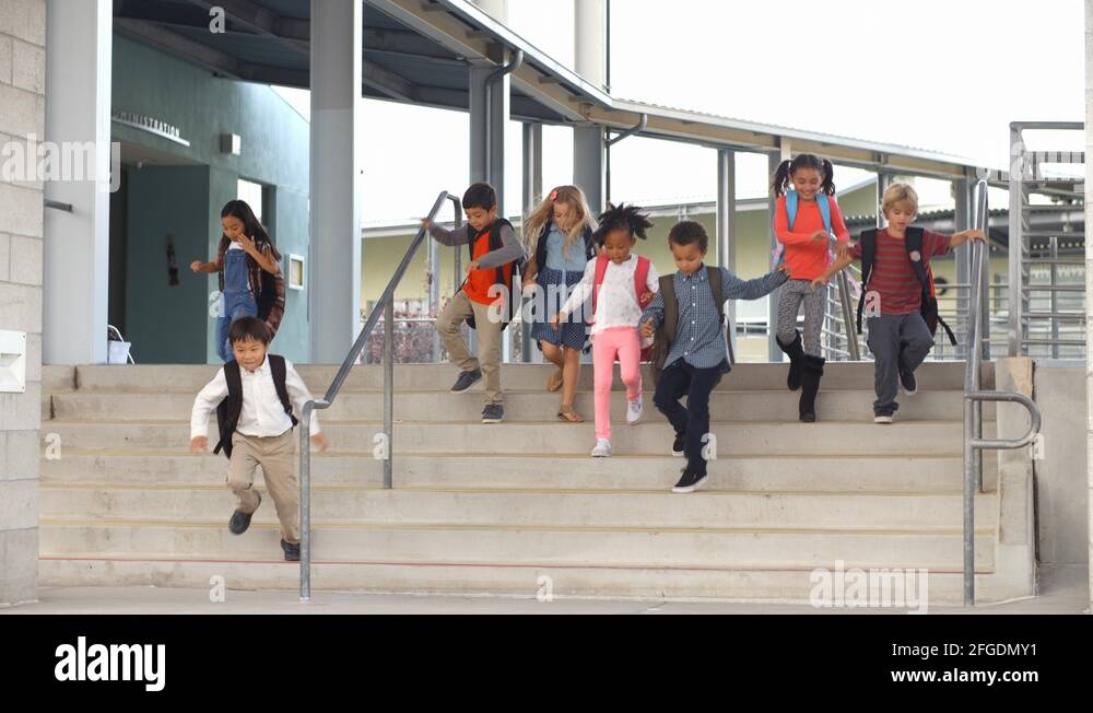 Young school kids jumping down steps as they leave school Stock Video ...