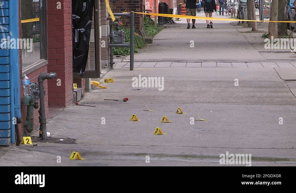 Police officers at shooting murder and crime scene in downtown Toronto ...