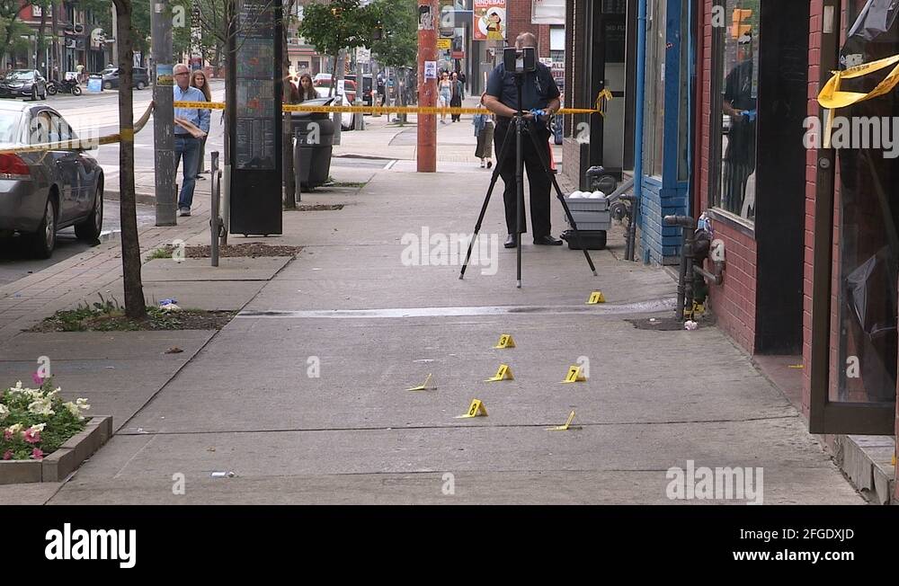 Police officers at shooting murder and crime scene in downtown Toronto ...