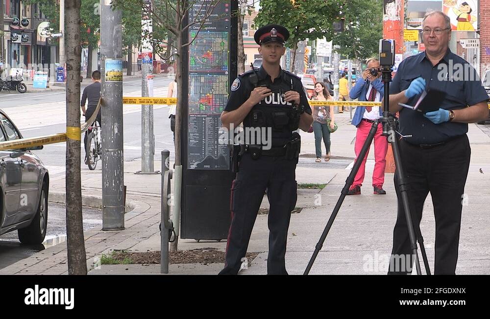 Police officers at shooting murder and crime scene in downtown Toronto ...