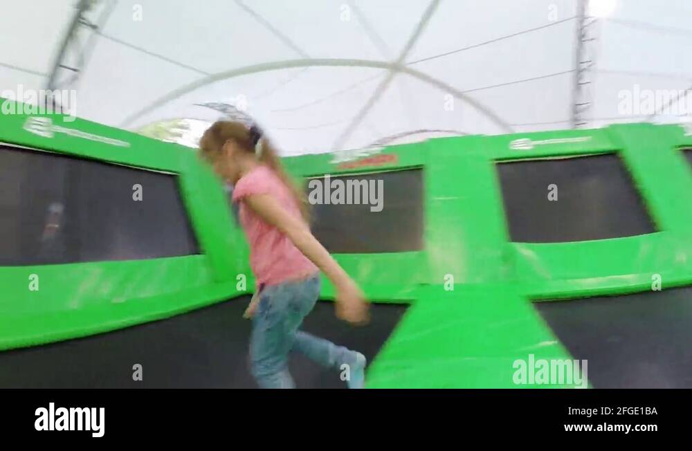 Girl with boy jump around on trampoline in park Sokolniki Stock Video ...