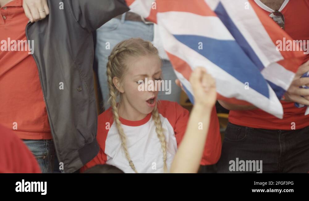 4K Excited fans with British flags in sports crowd cheering on the team ...