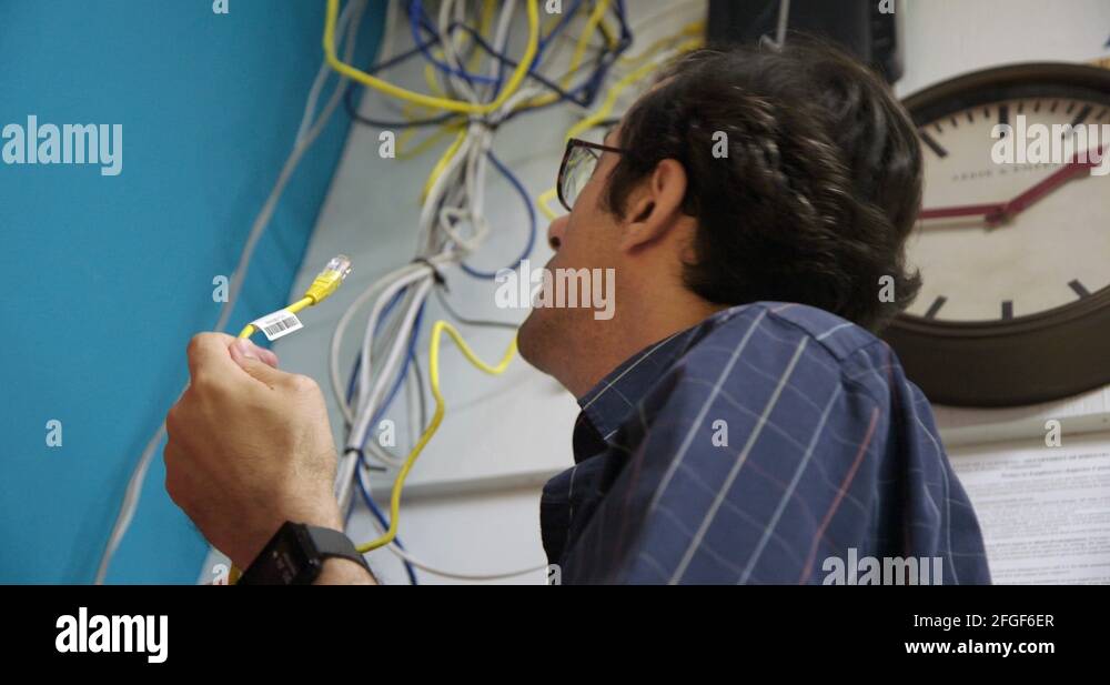 Business man regards office ethernet cables in horror and confusion 4K ...