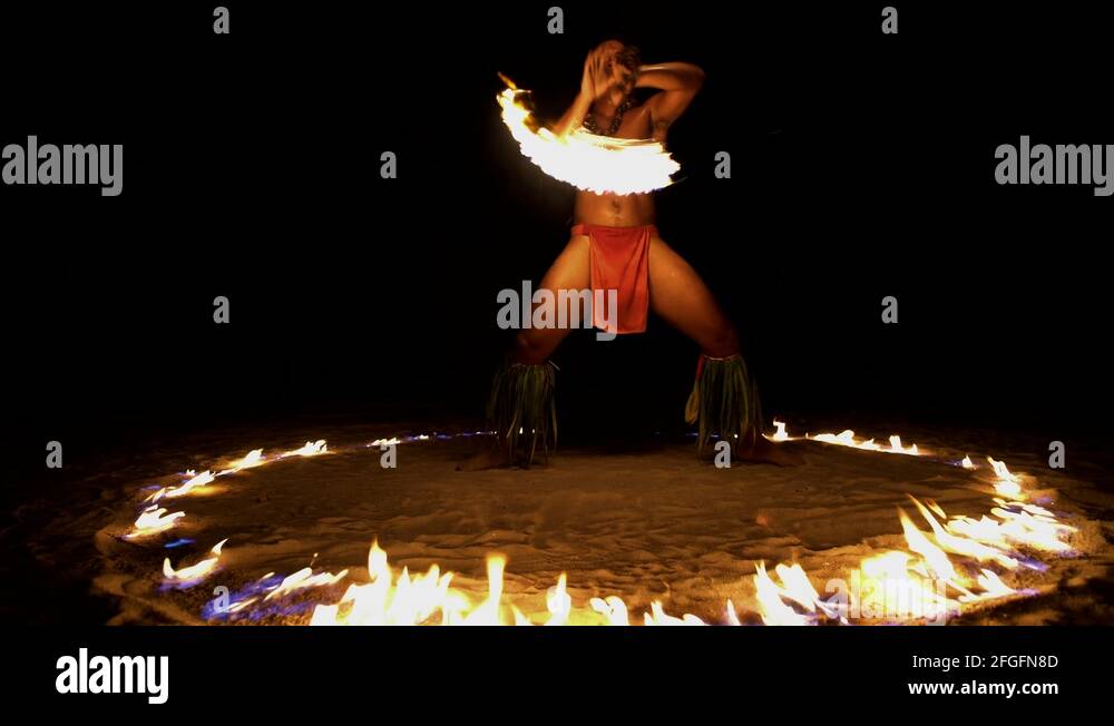 Polynesian male Fire dancer performing in a Ring of Fire while spinning ...