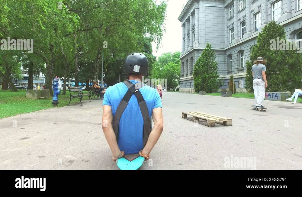 Cool guy longboarding lying down, having fun with friends Stock Video ...